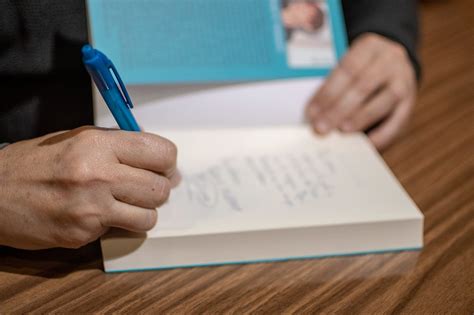 Person Writing A Book
