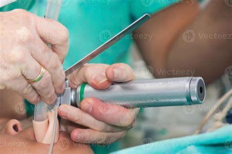 Anesthesiologist Performing An Endotracheal Intubation To A Female