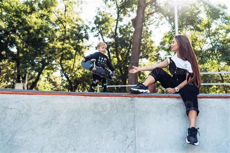 Beautiful Young Hipster Mom And Little Son At The Skatepark 11764216