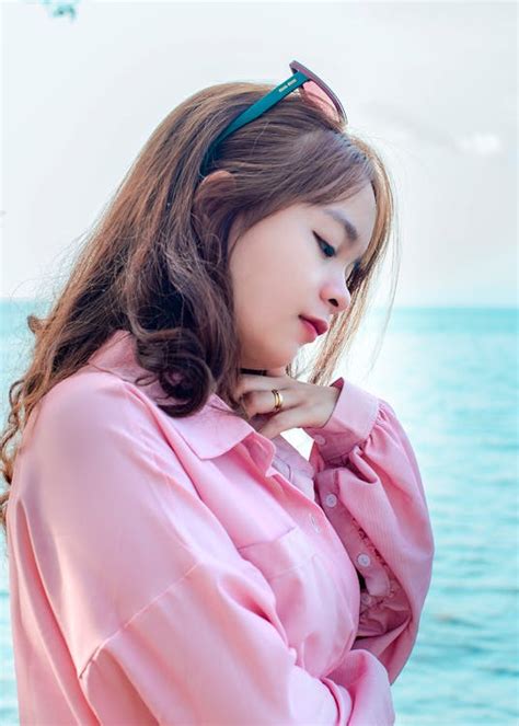 갈색 머리 긴 머리 내리막 길 분홍색 셔츠 선글라스 수직 쐈어 얼굴 여성 초상화 패션 사진 포즈를 취하는에 관한 무료 스톡 사진