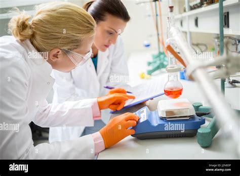 Female Technicians Adjusting Measuring Instrument In Laboratory Stock Photo Alamy