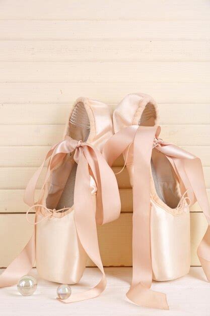 Premium Photo Beautiful Ballet Shoes On Creamy Wooden Background