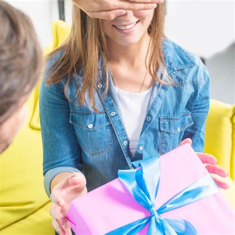 Hombre Dando Un Regalo Sorpresa A Su Novia Foto Gratis