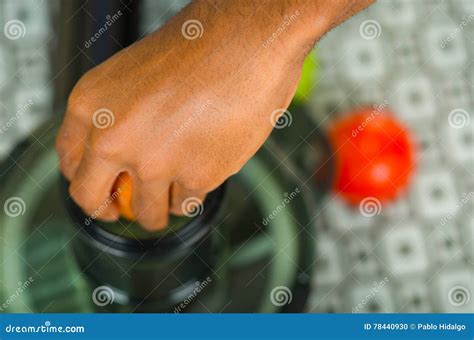 Closeup Man S Hands Using Juice Maker Inserting Carrot Into Machine