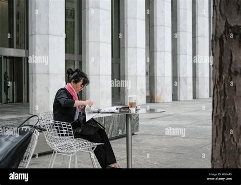 Female Adult Office Worker Seen Relaxing At A Public Place While