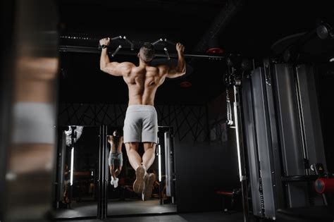 Premium Photo Fitness Man Pumping Up Muscle Doing Pull Ups Exercises