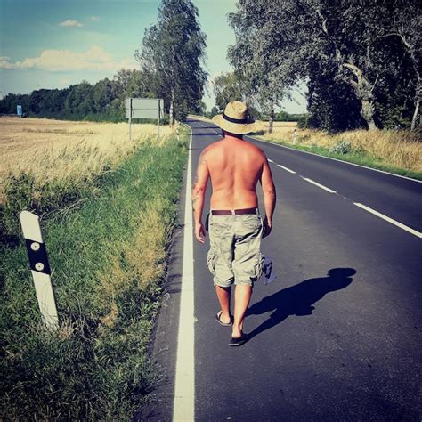 Premium Photo Rear View Of Shirtless Man Walking On Road