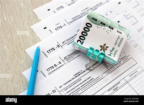 Annual Individual Income Tax Return Forms With Pen And Indonesian Rupiah Bills Original Name Is