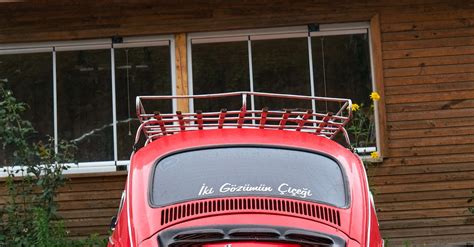 Red Volkswagen Beetle Parked Beside Brown Wooden Building · Free Stock