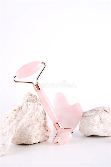 Pink Face Roller And Gua Sha Massager Quartz Stone Over White