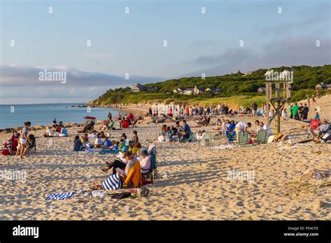 People Gather And Wait On Menemsha Beach To View The Sunset Over The Vineyard Sound In Chilmark