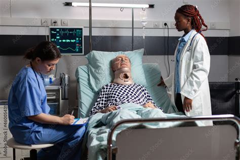 Zdjęcie Stock Injured Senior Man With Neck Brace Laying In Bed