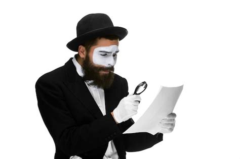 Free Photo Man With A Face Mime Reading Through Magnifying Glass