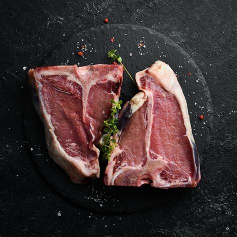 Premium Photo Raw Aged T Bone Steak On A Black Stone Background Top View Rustic Style