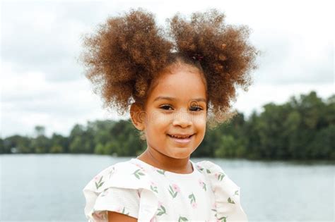 Charming Dark Skinned Girl On The Beach Next To The Lake Stock Image