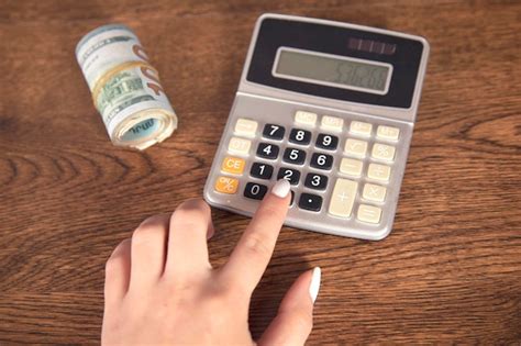 Premium Photo Woman Hand Calculator And Dollar