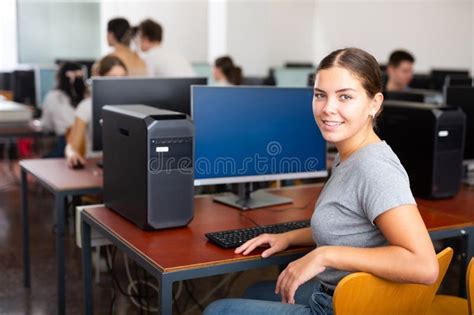 Positive Female Babe Smiling Using PC And Studying Computer Science In The Classroom Stock