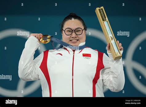 Gold Medalist Li Wenwen Of China Celebrates On The Podium During The Medal Ceremony For The