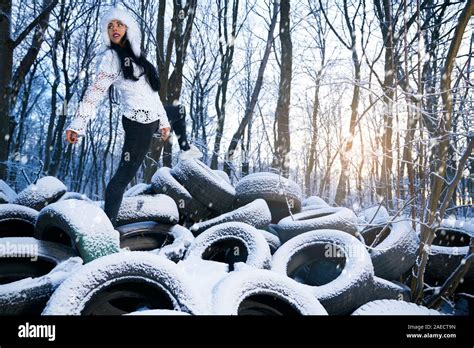 Stylish Model Posing On Old Used Tires Dumping In Forest Beautiful