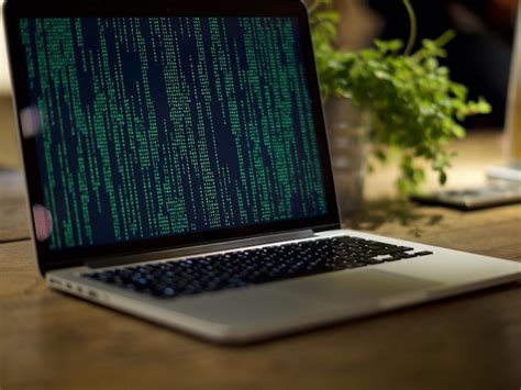 Premium Photo Binary Codes On Laptop Screen At Table