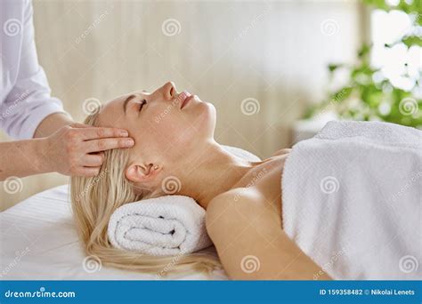 Beautiful Woman With Closed Eyes Getting A Massage In The Spa S Stock