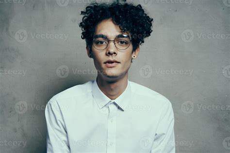 Portrait Of A Happy Guy With Glasses Curly Hair White Shirt Photoshoot