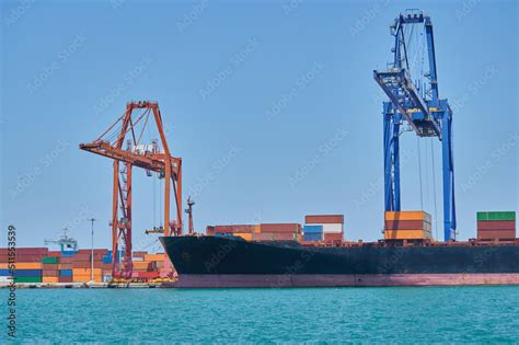 Port Crane Loading And Unloading Containers Onto A Ship Maritime Trade Concept Stock Photo