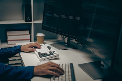 male programmer working on desktop computer at white table in office