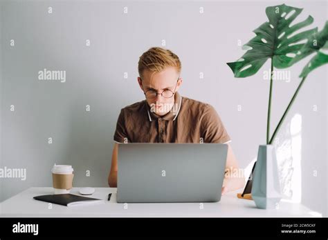 Focused Man In Glasses Mobile Developer Programmer Writes Program Code