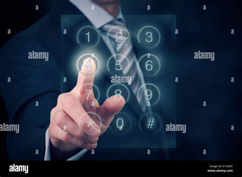 A Businessman Entering A Password Onto A Glass Screen Keypad Stock