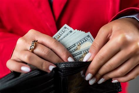 Young Beautiful Woman With Fragile Hands Takes Out Many Dollars From