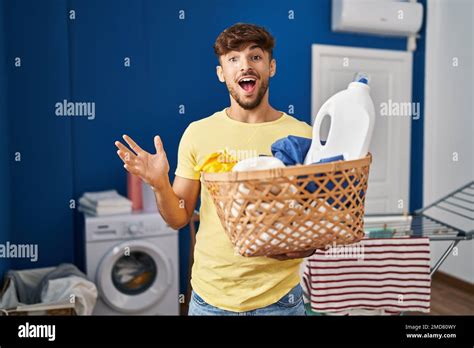 Arab Man With Beard Holding Laundry Basket And Detergent Bottle