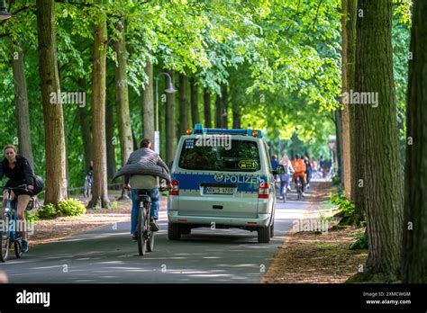 Police Patrol On The Promenade Cycle Path A Tree Lined Car Free