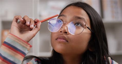 Closeup Of Young Asian Active Girl Glasses Thinking While Sitting At