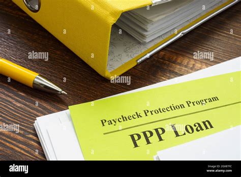 Paycheck Protection Program Or Ppp Loan Papers And Yellow Folder Stock