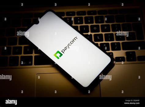 In This Photo Illustration A Paycom Logo Seen Displayed On A