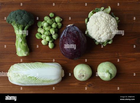 Different Types Of Cabbage On A Brown Wooden Table View From Above