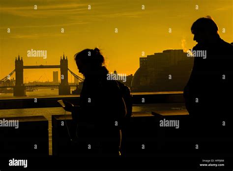 Commuters Walk Over London Bridge On A Cold Sunny Morning With Freezing