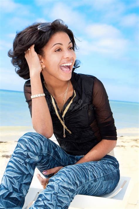 Beautiful Caribbean Brunette Sitting On The Beach Stock Image Image