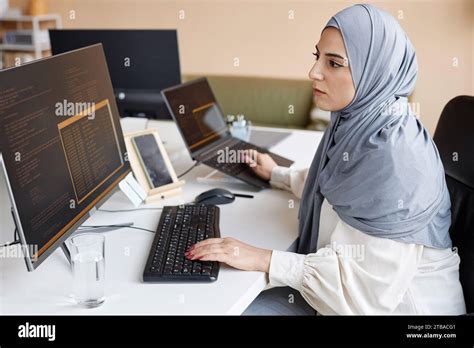 Side View Portrait Of Muslim Young Woman Wearing Modest Clothing In