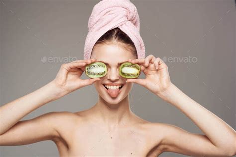 Woman Holds Near Eyes Kiwi Naked Shoulders Clean Skin Gray Background Stock Photo By Shotprime