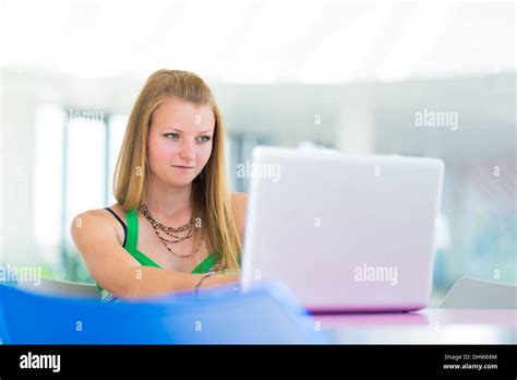 Pretty Female College Student Working On Her Laptop Computer On Campus