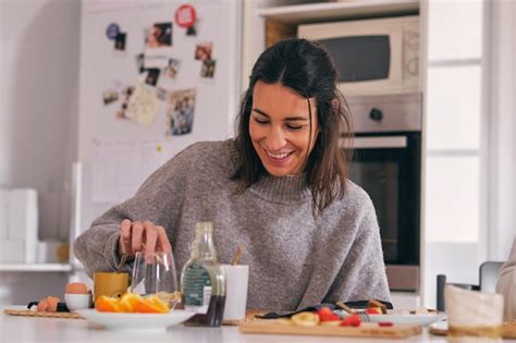 Premium Photo Content Adult Female At Table With Fresh Fruit Slices