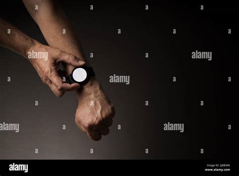 Man S Hand With Fingers Pressing Smart Watch On Wrist Displaying Blank White Screen Isolated