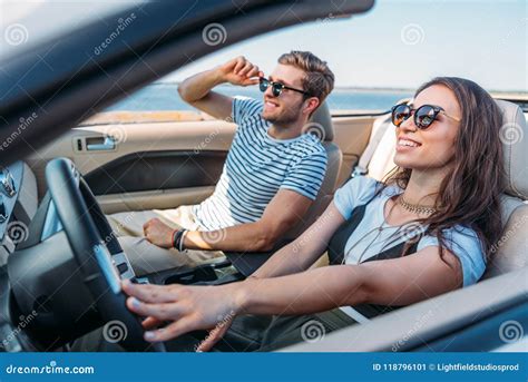 Multicultural Young Couple Riding Car At Seaside While Stock Image