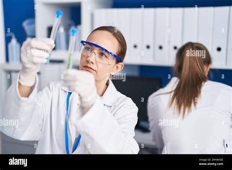 Two Women Scientists Holding Test Tubes At Laboratory Stock Photo Alamy