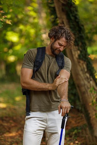 A Young Traveller With Backpack Has Problems With Mosquitoes In Forest