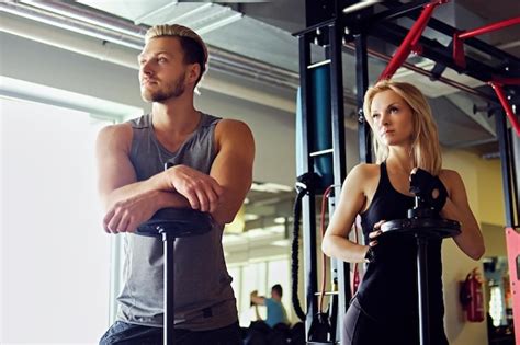 Premium Photo Blond Muscular Male And Athletic Blond Female Hold A