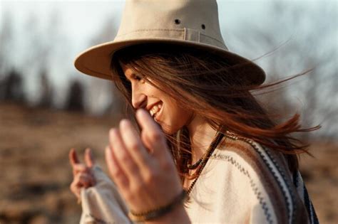 Premium Photo Beautiful Boho Woman Hipster Portrait Smiling Wearing Hat And Poncho At Sunset