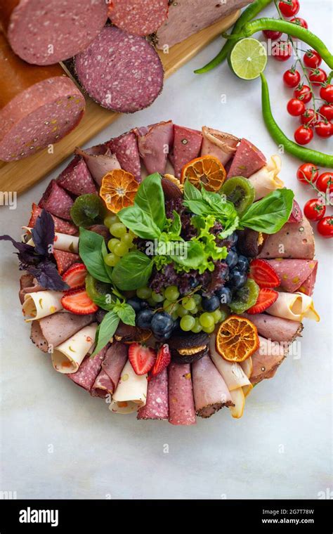 Meat Plate On A White Wooden Background Set Of Salami Cold Cuts Of Different Types Of Meat